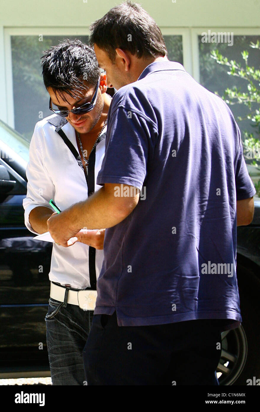 Peter Andre signs an autograph for a fan before leaving his Brighton ...