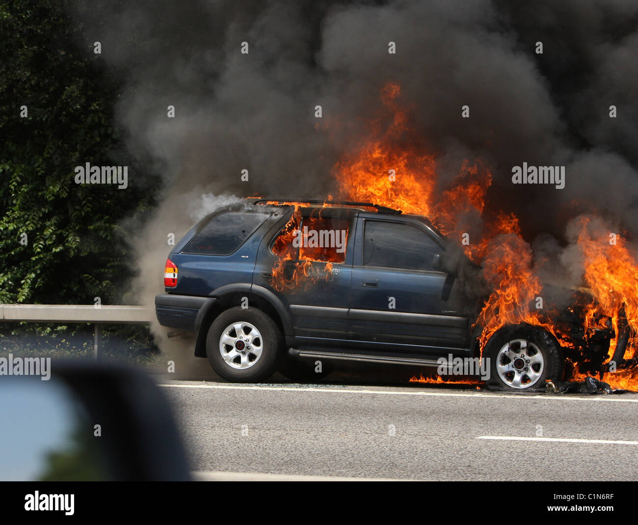 A car catches fire on the M4, near London England - 01.07.09 Stock ...