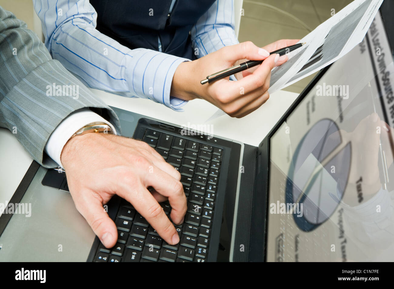 Photo of male hands typing letter with male hands pointing project ...