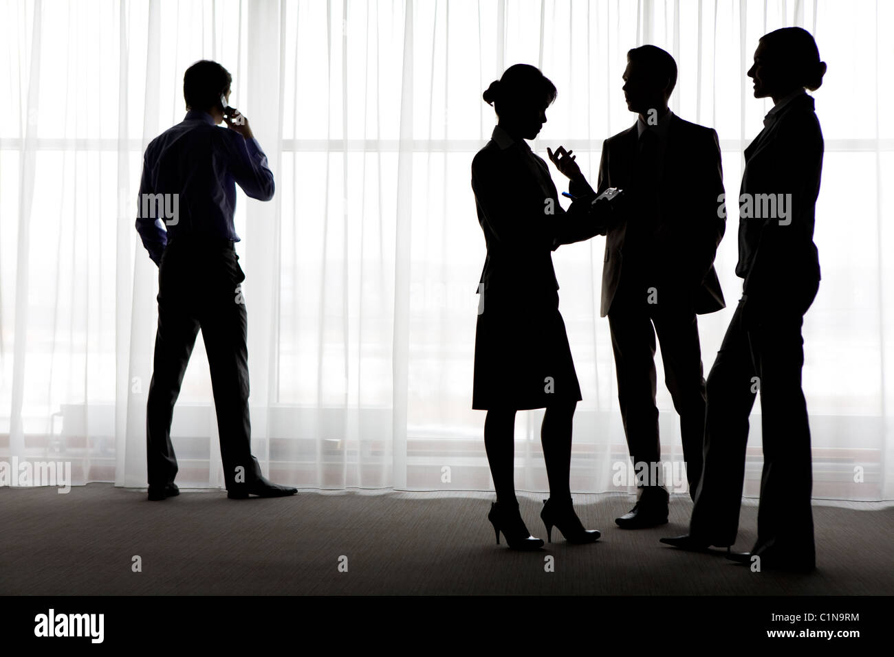 Four outlines of business partners communicating with calling male near ...