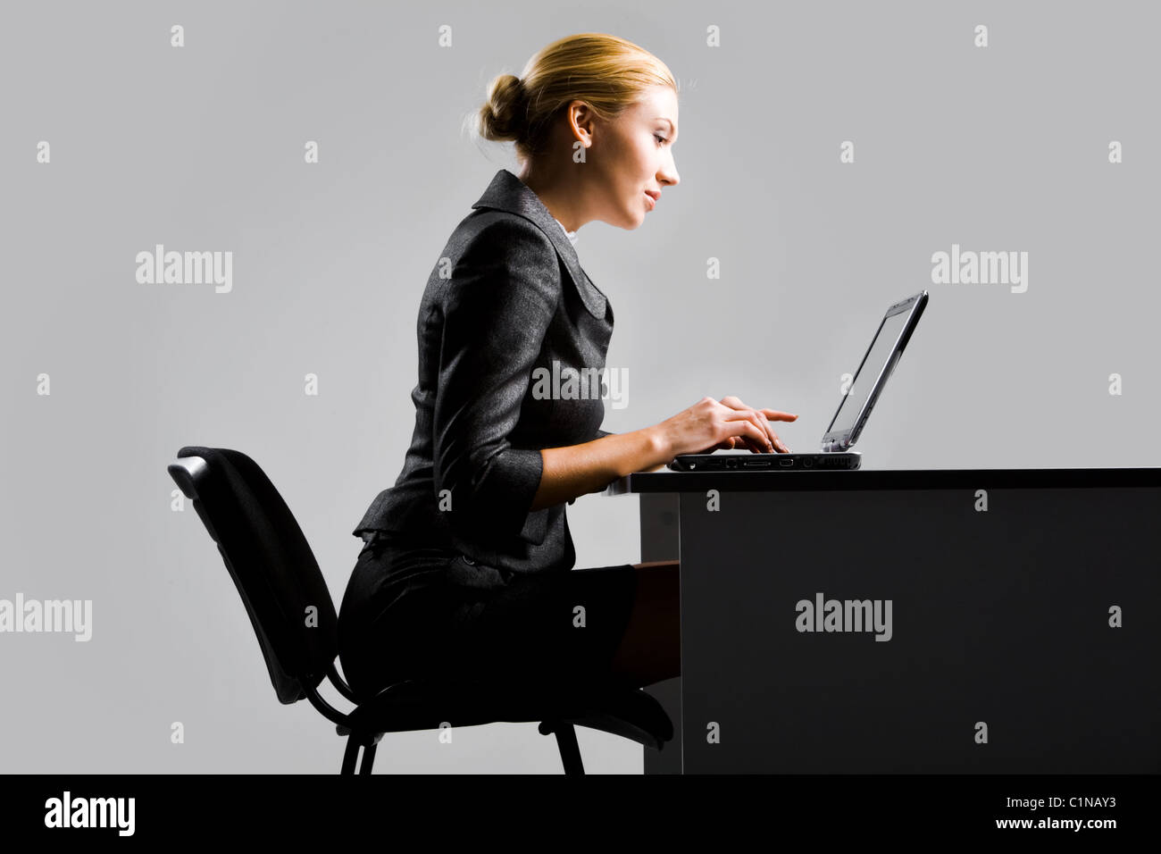 Photo of pretty secretary typing on laptop at workplace Stock Photo - Alamy