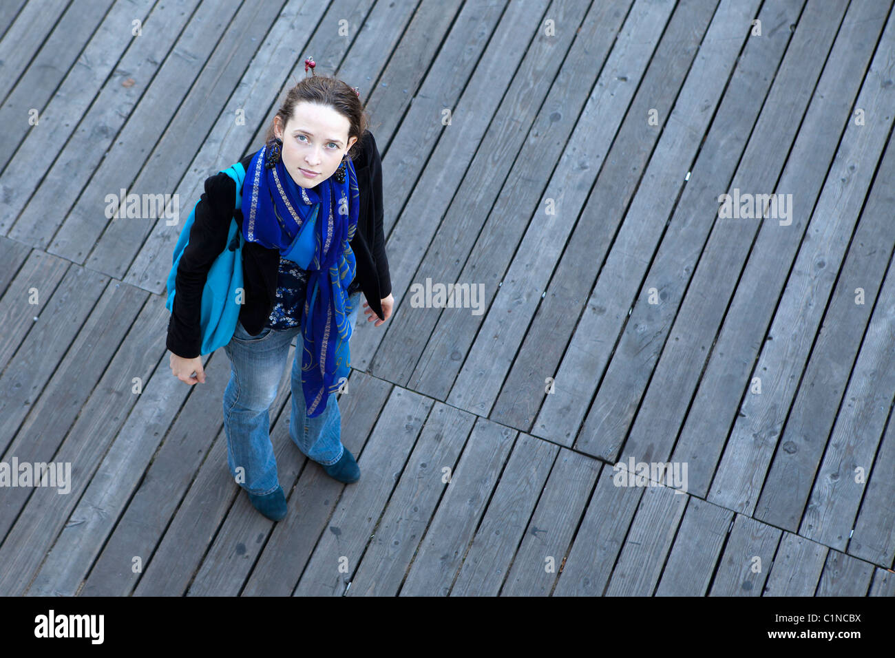 young beautiful female standing at bridge looking up Stock Photo - Alamy