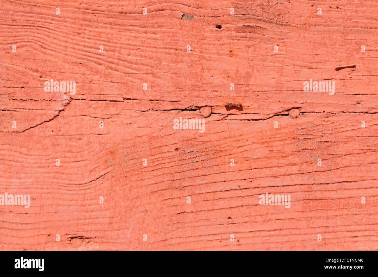 macro of a plank of weathered wood painted red in the sunlight Stock ...