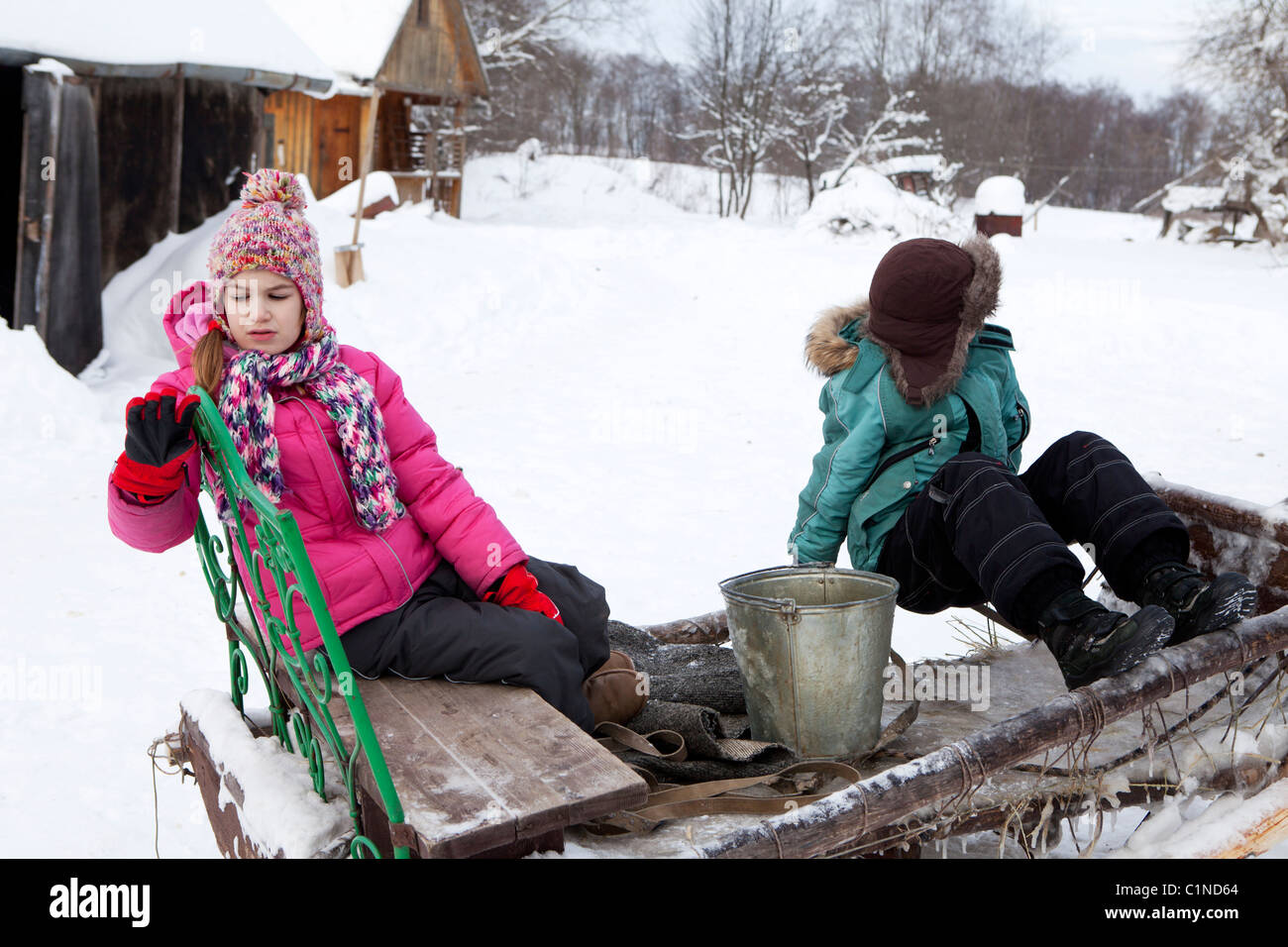 Russian, rural the boy and girl on sledge in the winter Stock Photo - Alamy