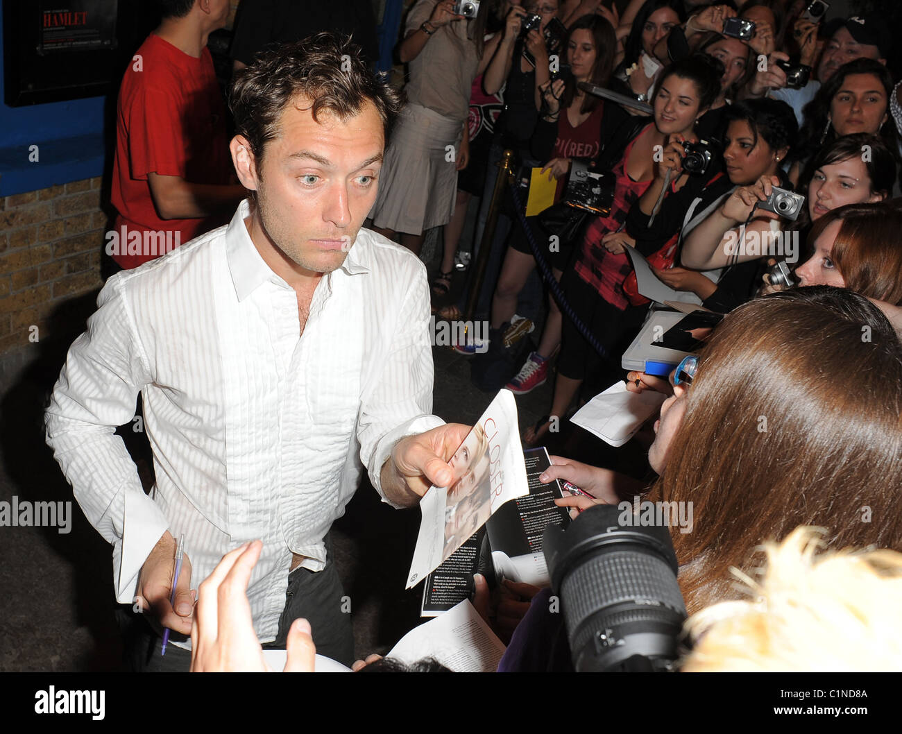 Jude Law is swamped by a huge number of fans wanting his picture and ...