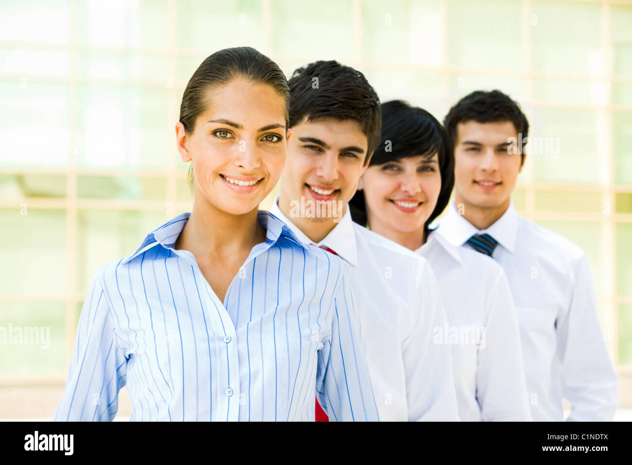 Portrait of attractive leader of friendly business group standing in ...
