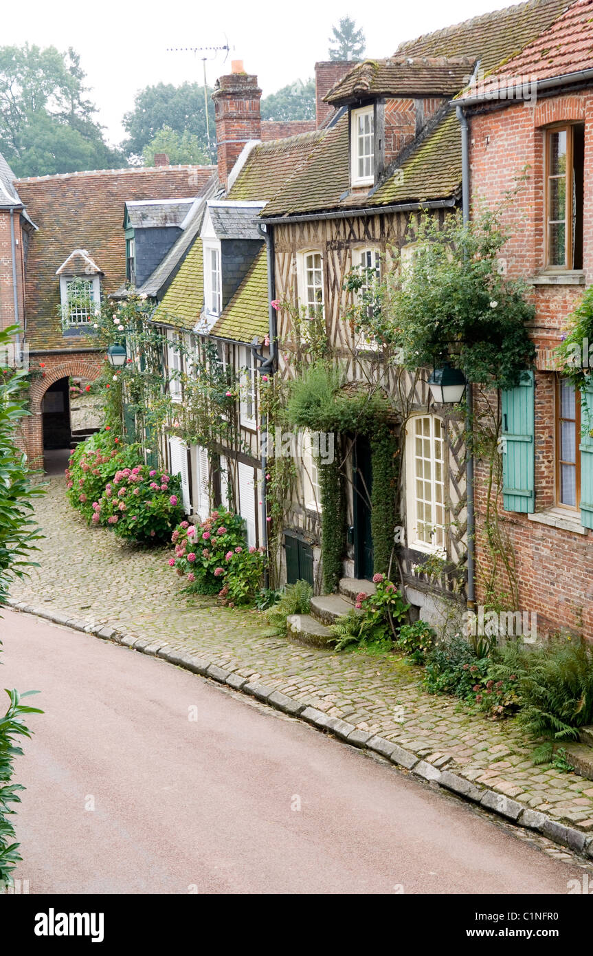 Exterior facade of 18th century French brick house on cobbled street in ...