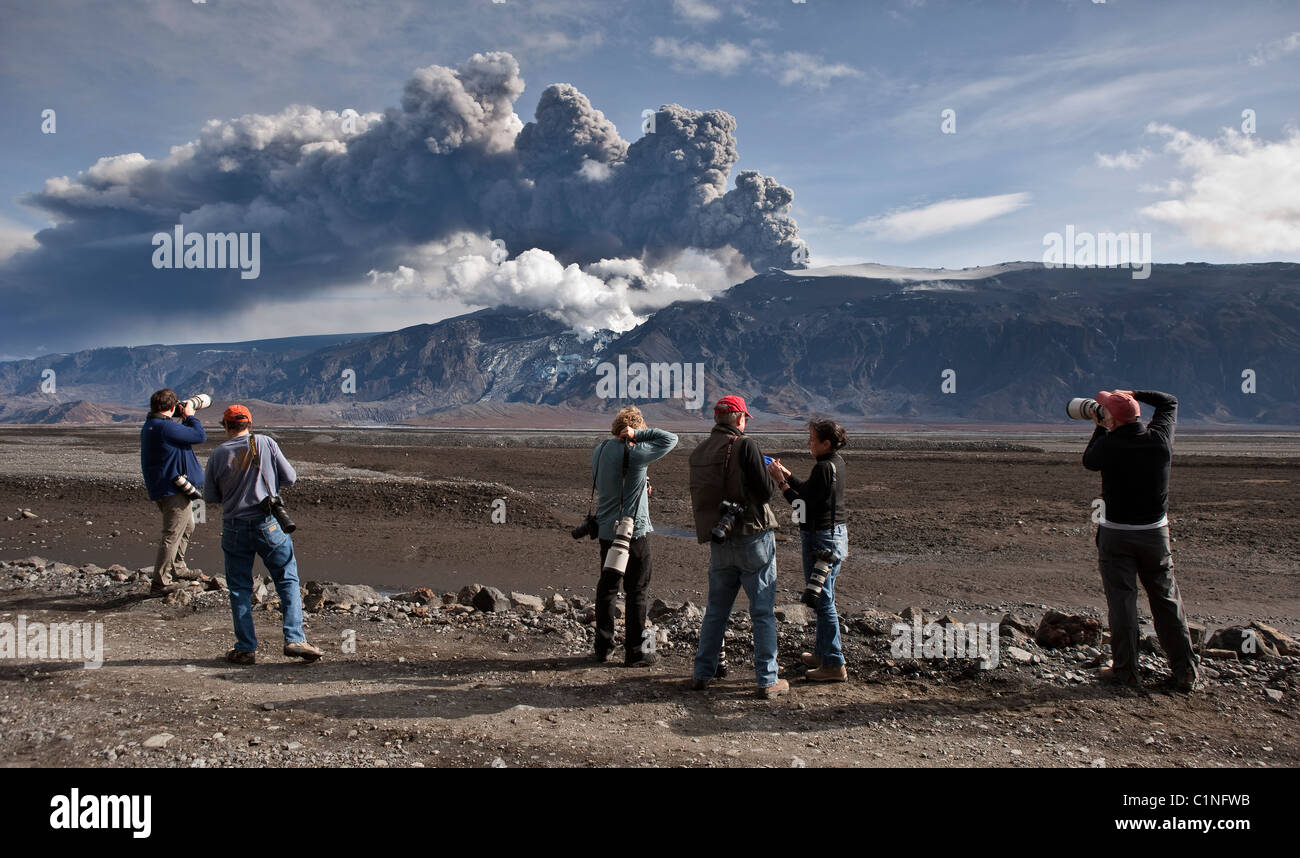 Tourist photographing Eyjafjallajokull volcano erupting, Iceland March ...