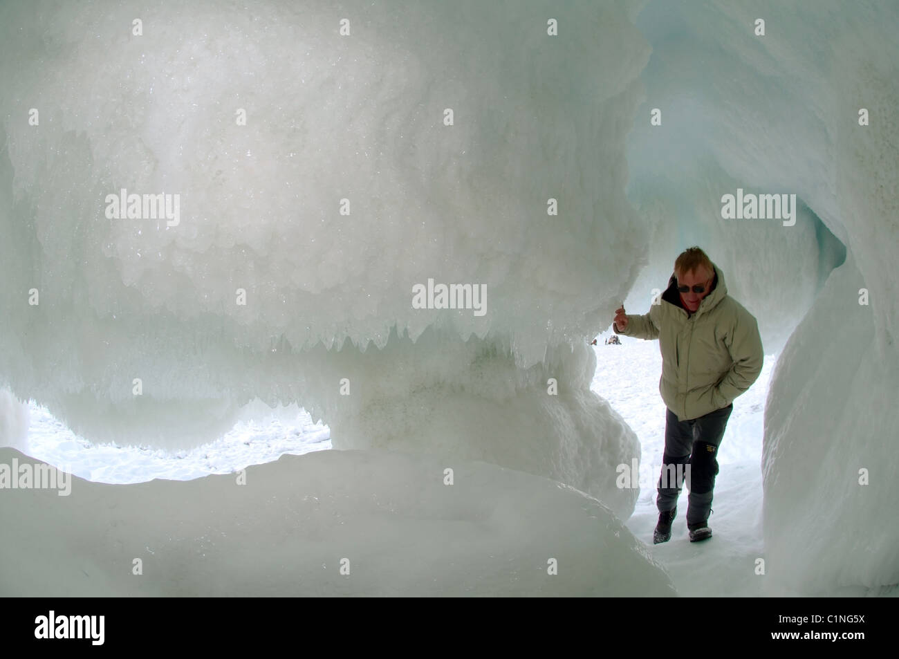 man walks into an ice cave Stock Photo - Alamy