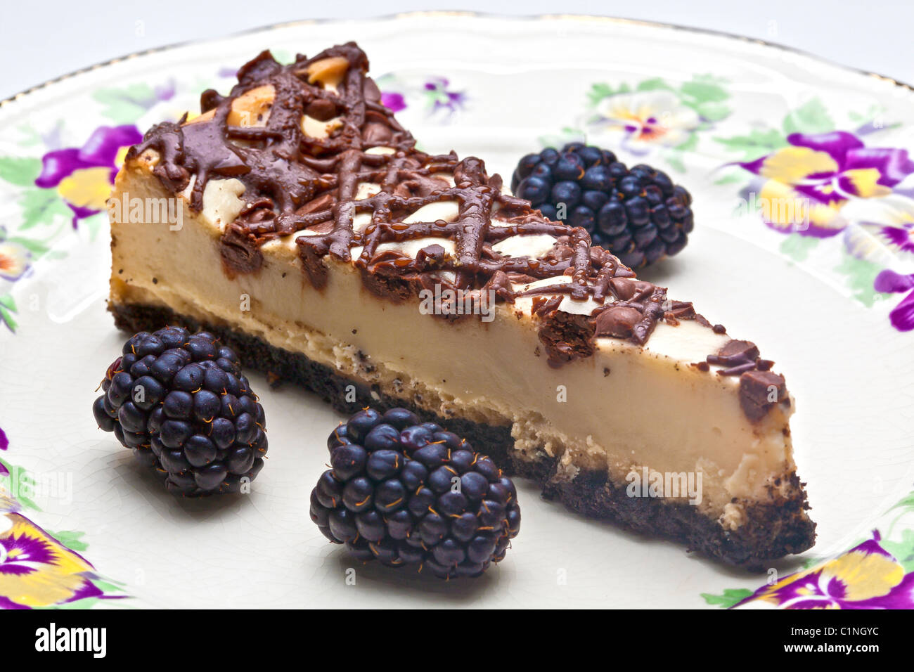 slice of chocolate covered cheesecake on decorative plate Stock Photo ...