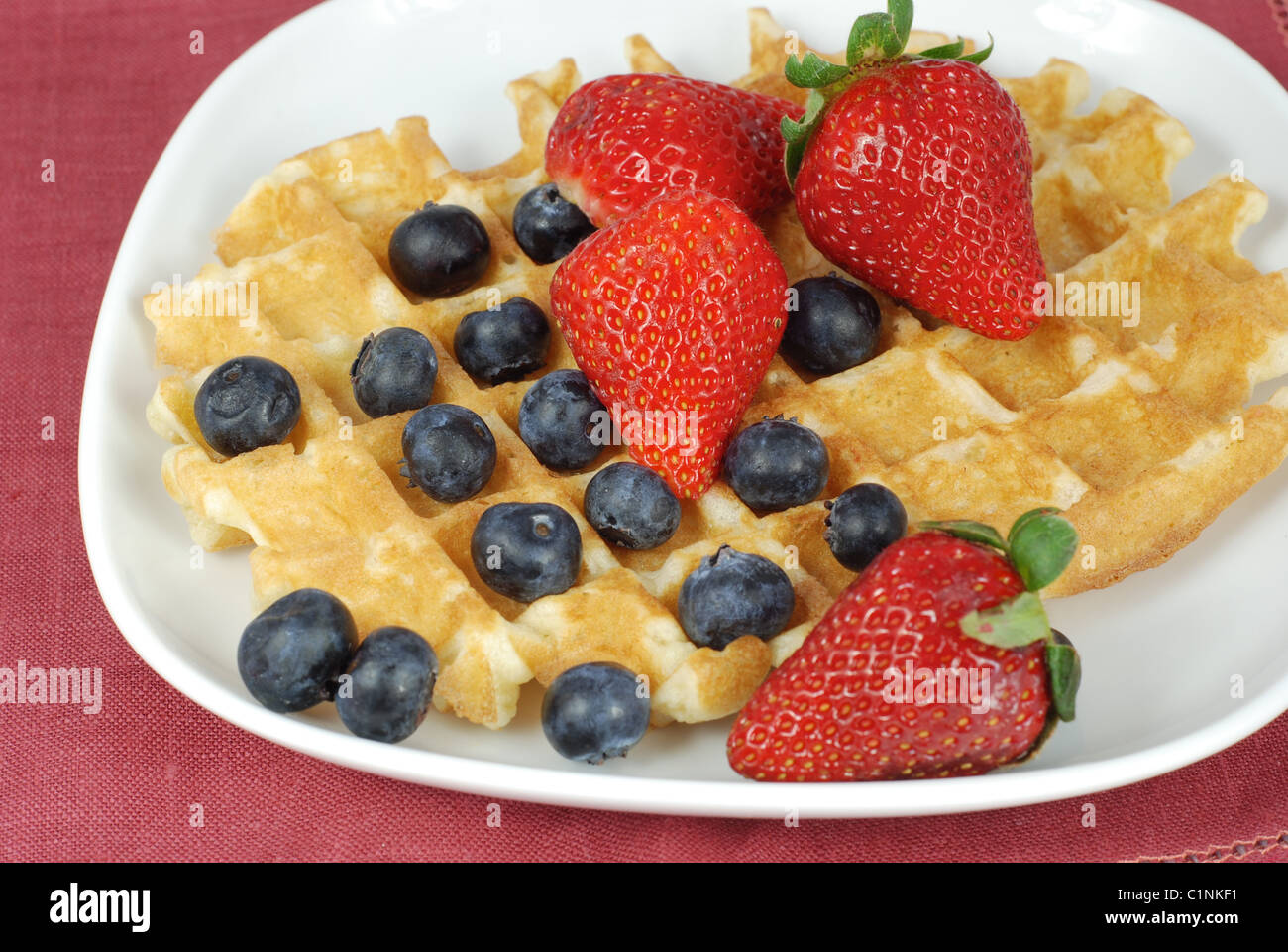 Belgian waffle with strawberry and blueberry Stock Photo - Alamy