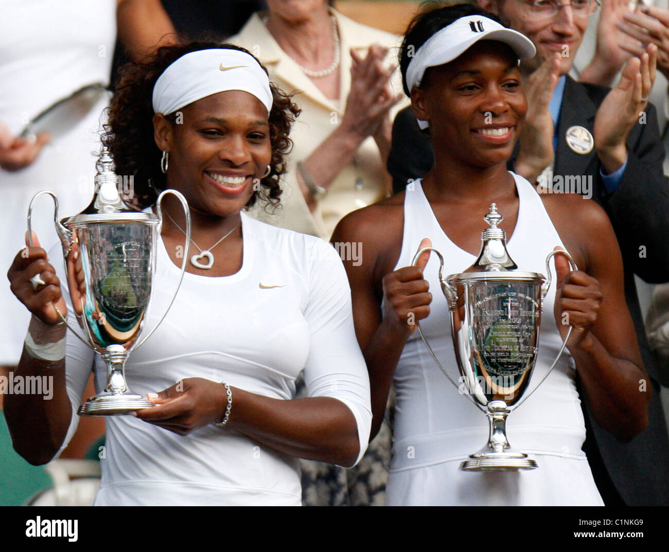Venus Williams and Serena Williams of the United States hold up their ...