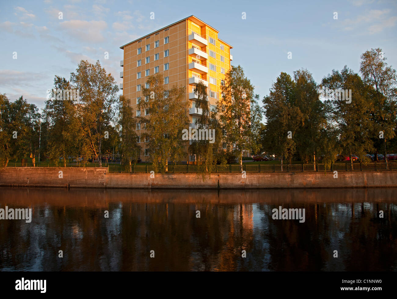 Yellow old fashioned block of flats by a canal , Oulu Merikoski Finland ...