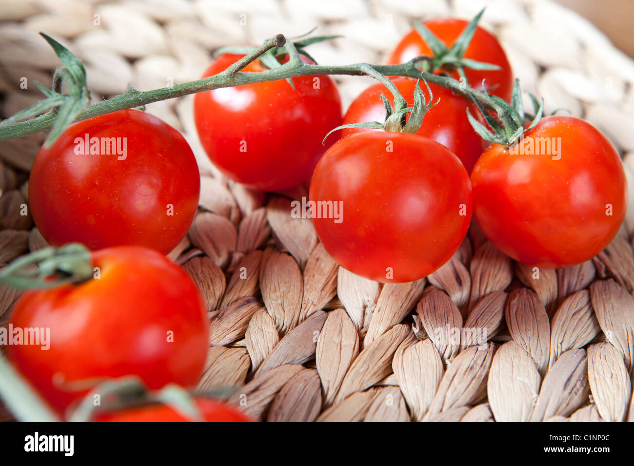 Red, ripe tomatoes in the wattled basket Stock Photo - Alamy