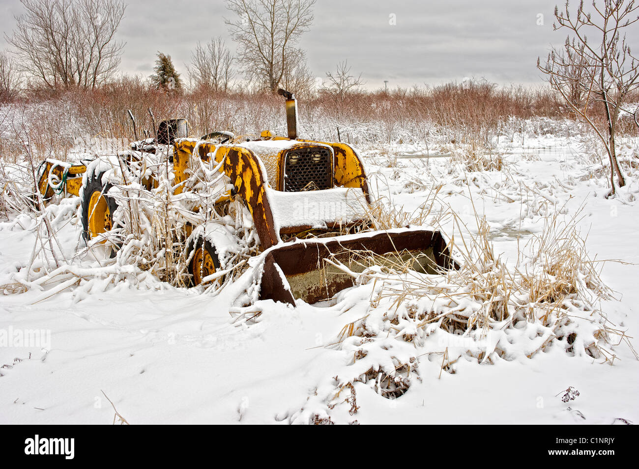 Old rusted out bulldozer in the snow in a farmer's field Stock Photo ...