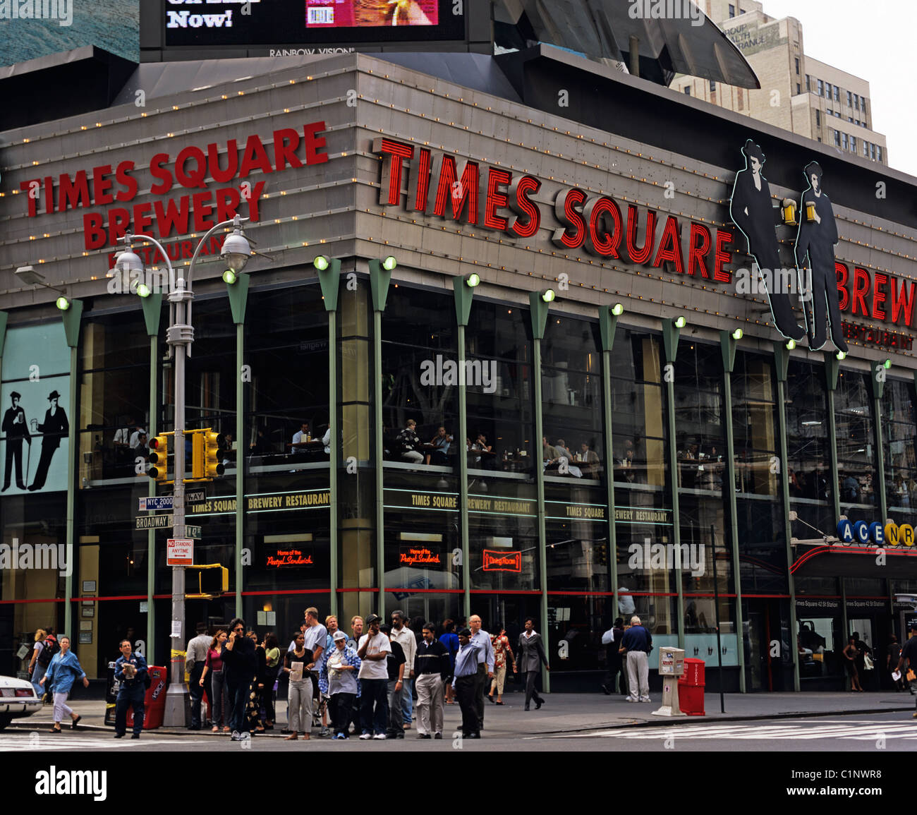People crossing the street outside Times Square Brewery. New York city ...