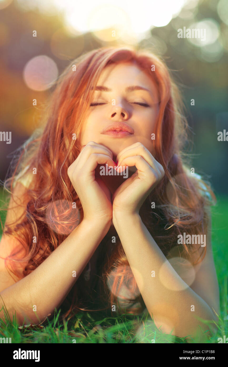 Woman showing heart shape with her hands on stomach Stock Photo - Alamy