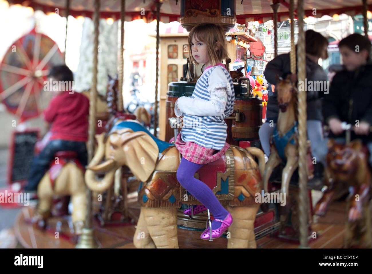 Children riding a vintage merry go round in Rouen, France Stock Photo ...