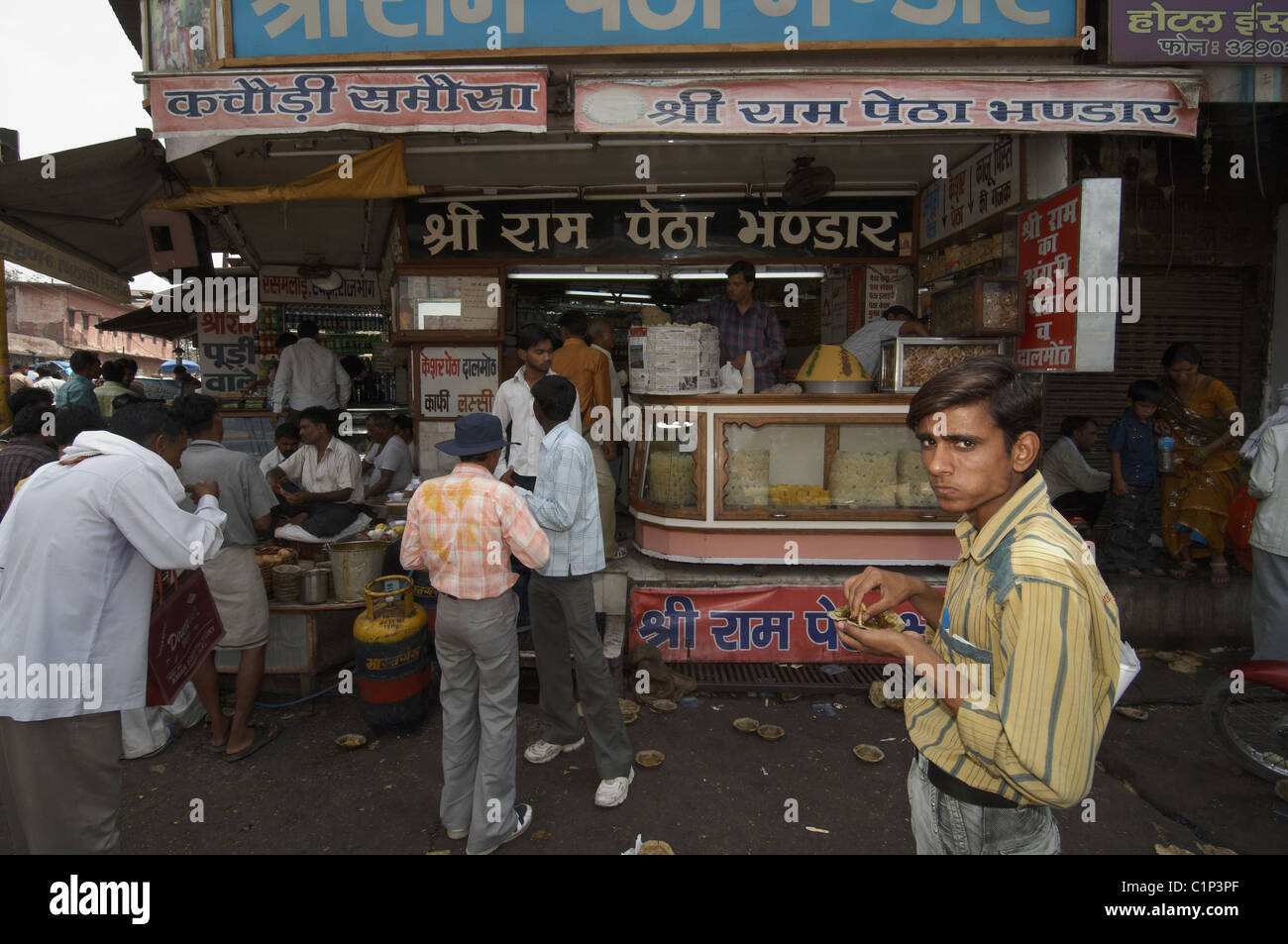 Indian man eats outside a fast-food stall in Agra, India Stock Photo ...