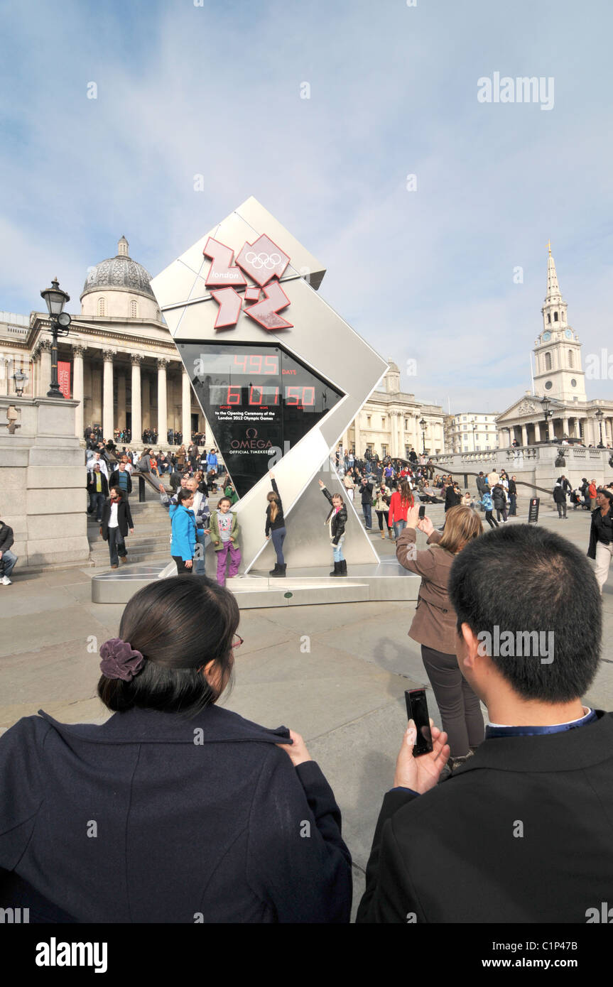 London 2012 Olympics clock Trafalgar Square tourists posing Stock Photo ...