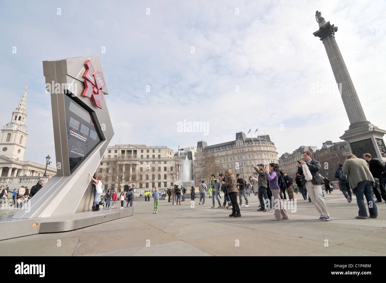 London 2012 Olympics clock Trafalgar Square tourists posing Stock Photo ...
