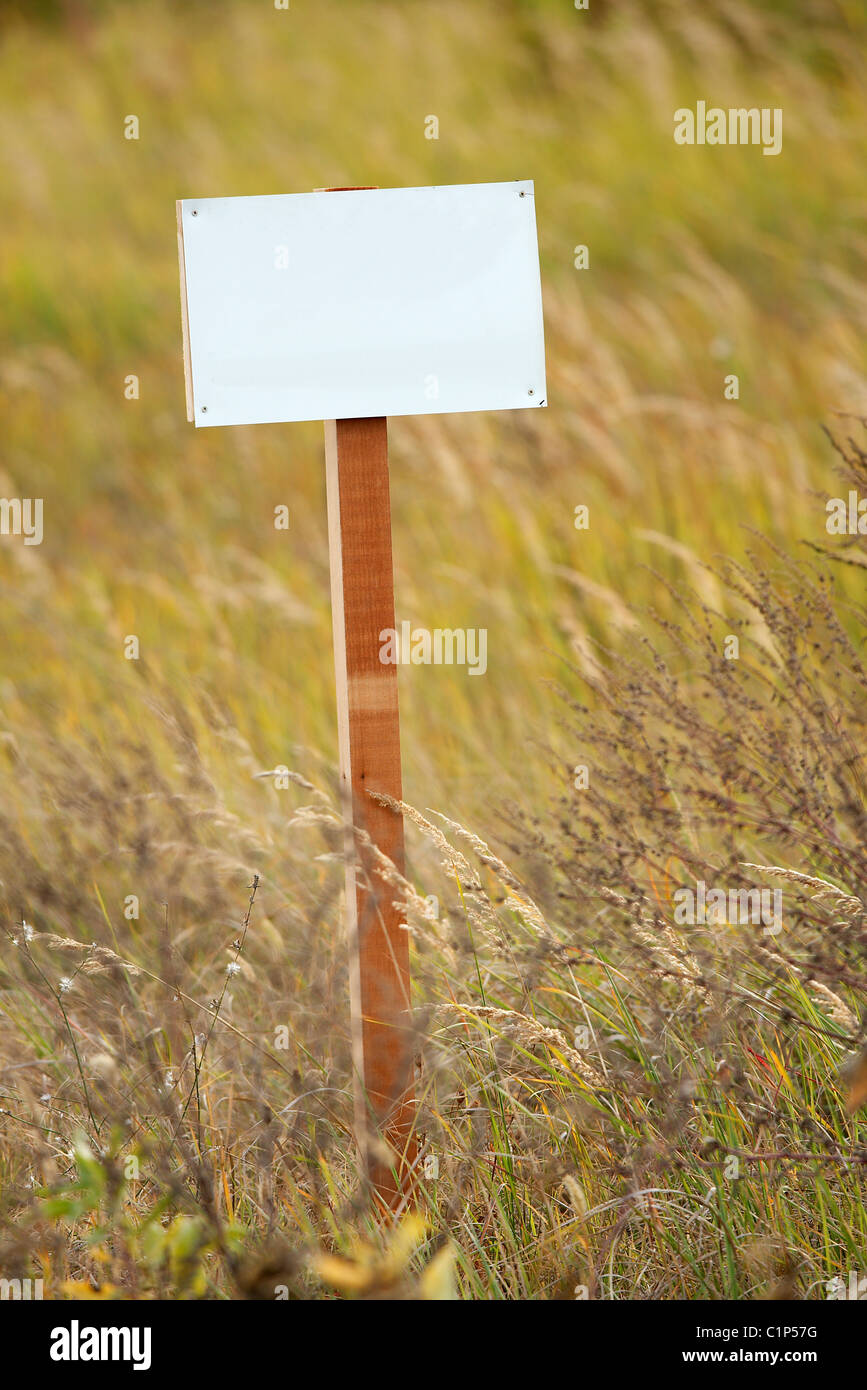 Blank sign board on a field Stock Photo - Alamy