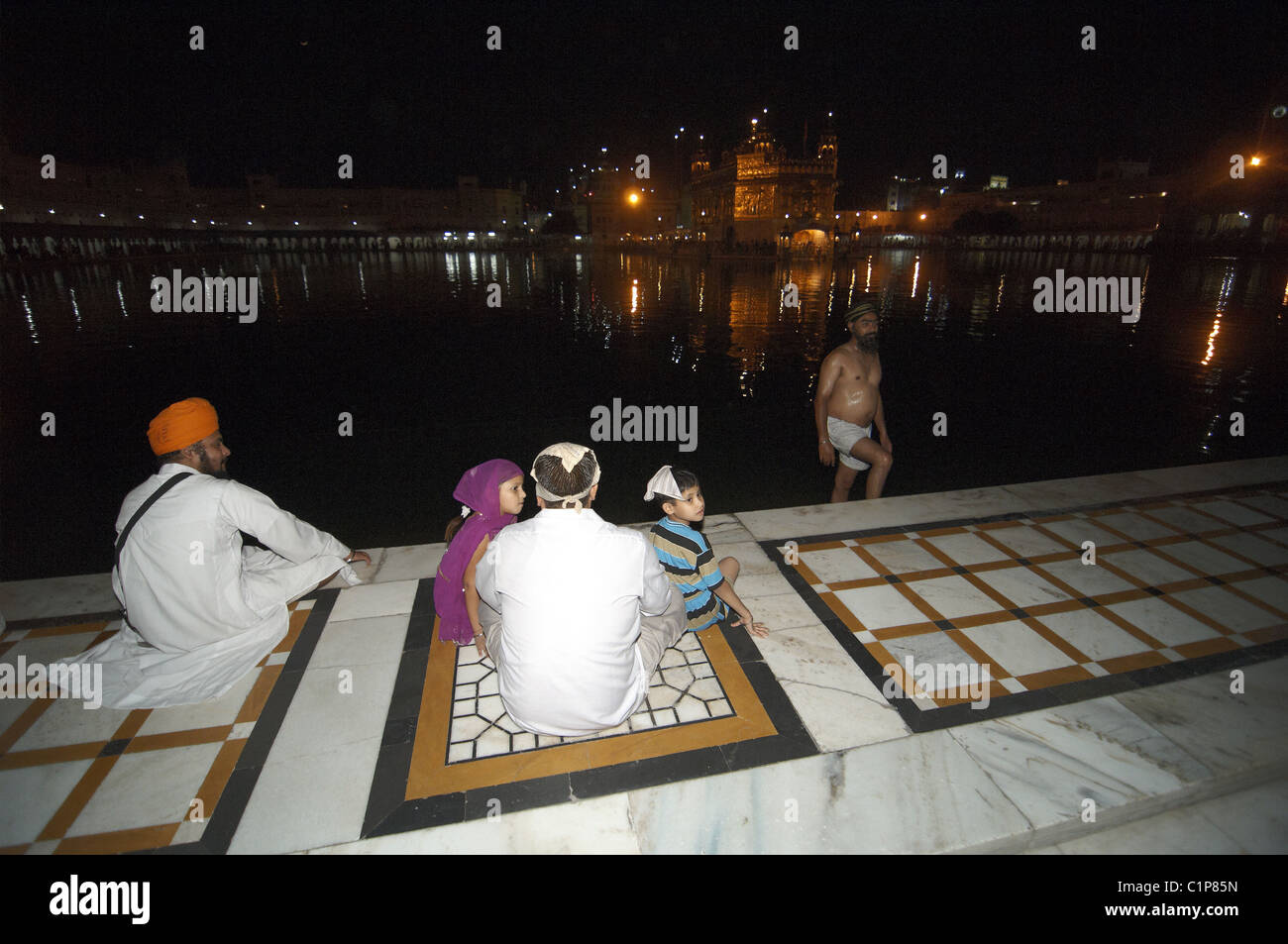 Sikh man climbs out of the water at the Golden Temple at Amritsar ...