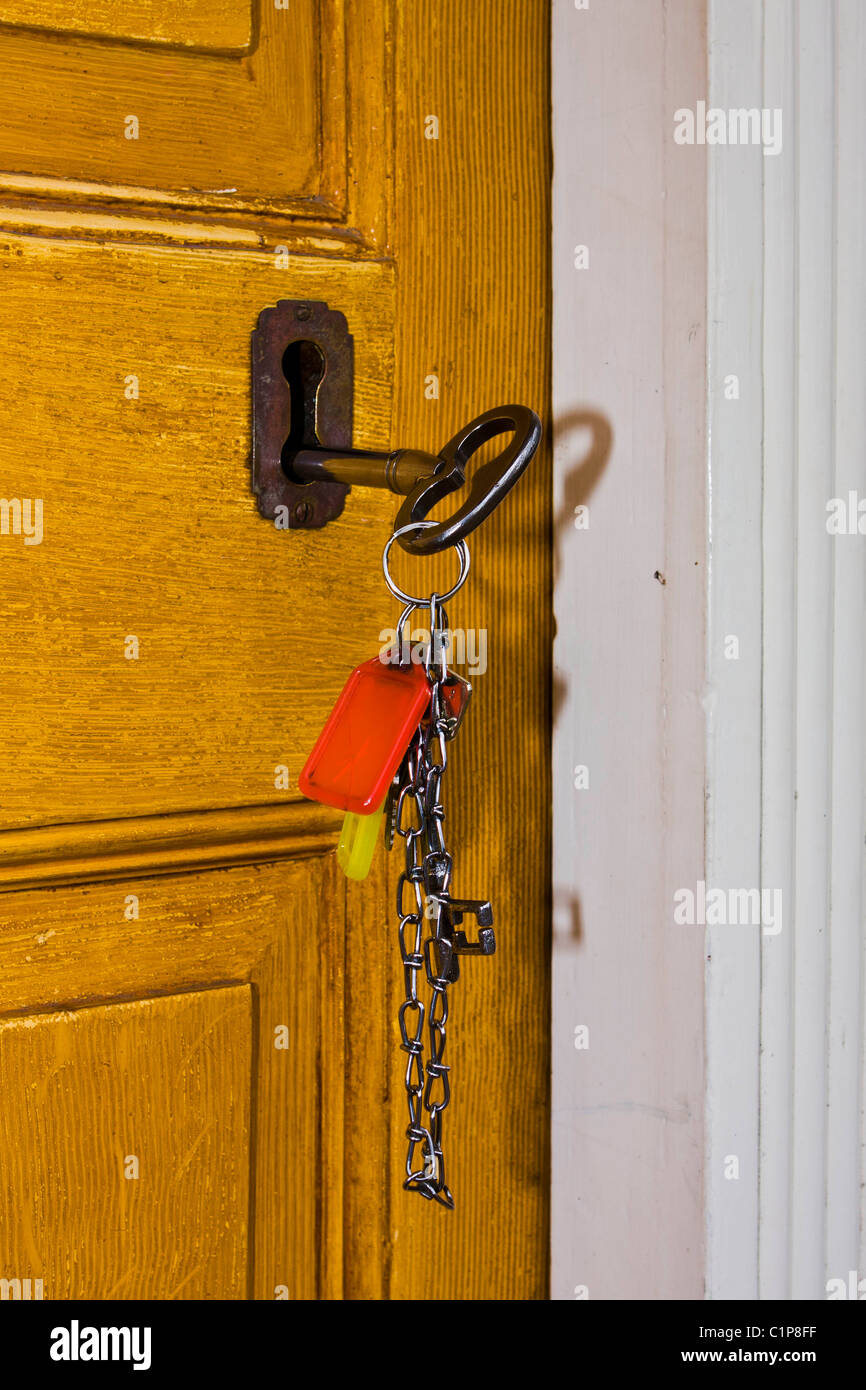 An old key inserted in a lock Stock Photo - Alamy