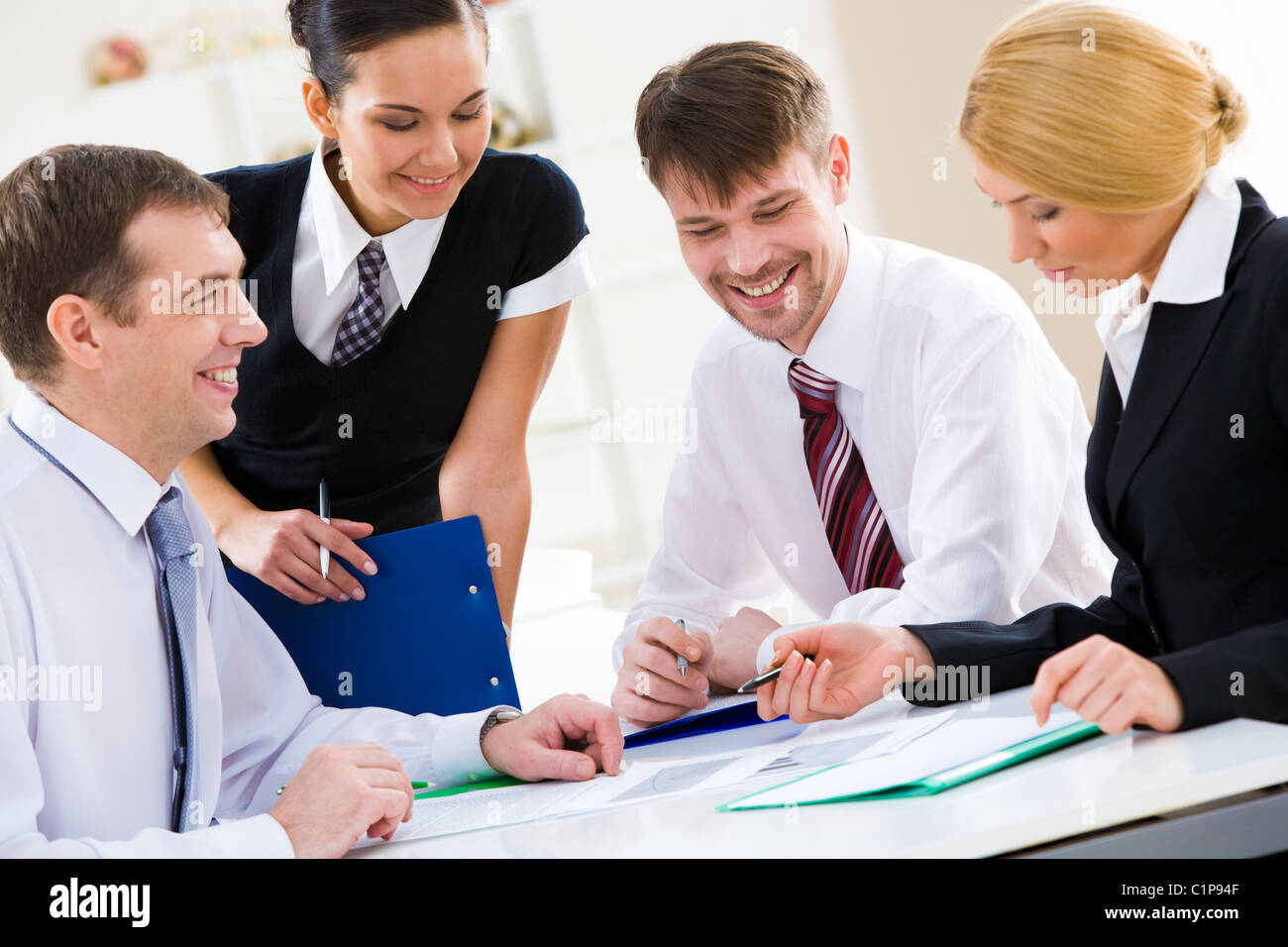 Portrait of busy people discussing new project or working plan Stock ...
