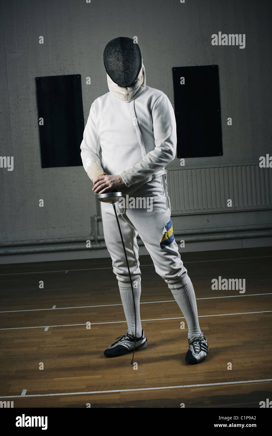 Portrait of fencer wearing face guard in sports hall Stock Photo - Alamy