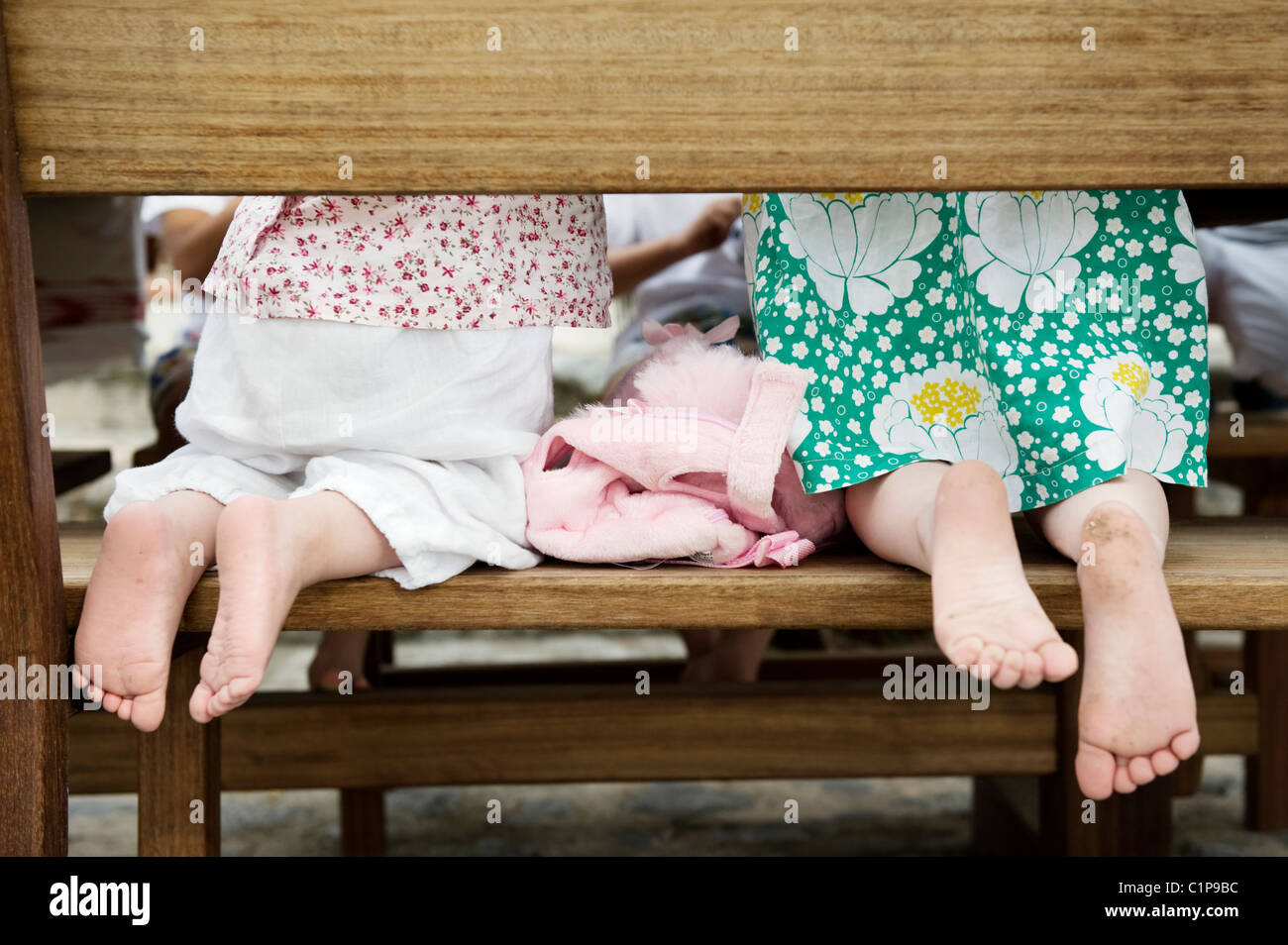Children kneeling on bench, low section Stock Photo - Alamy