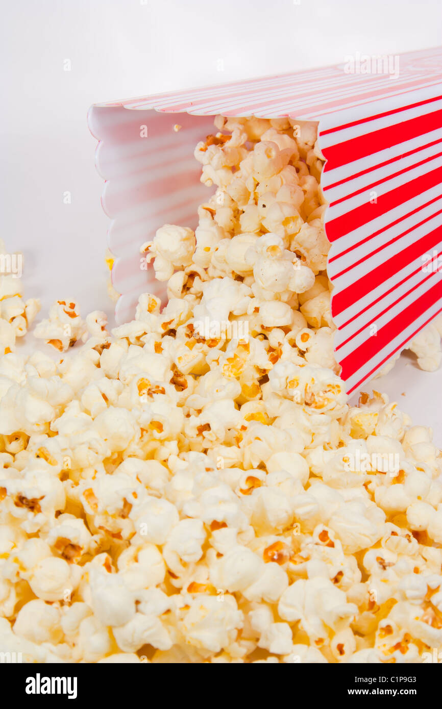 Picture of popcorn falling out of a holder Stock Photo - Alamy