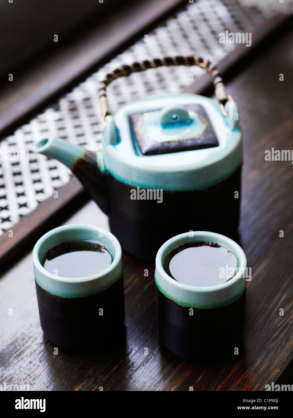 Two cups of tea beside teapot Stock Photo - Alamy