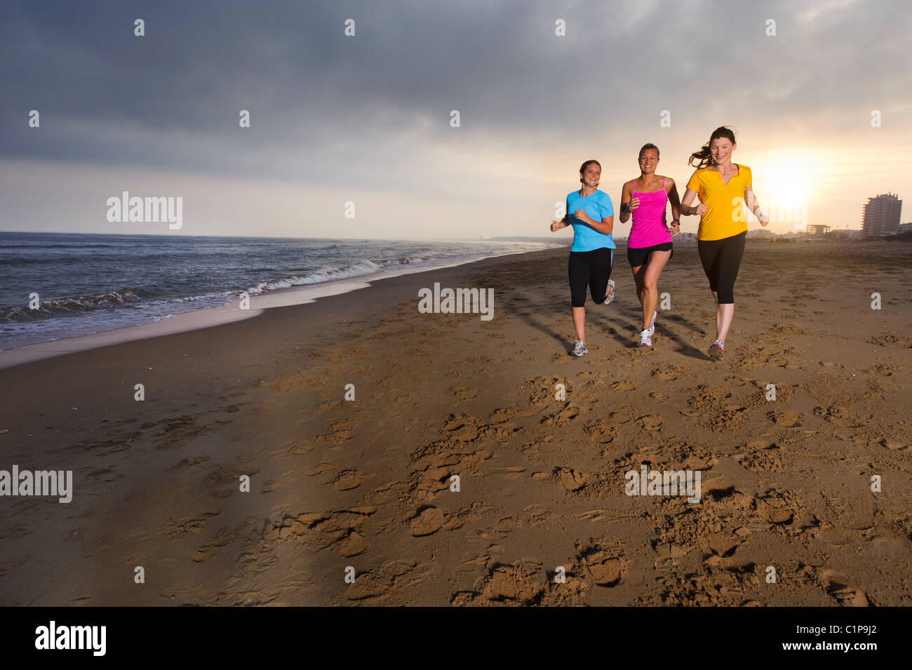 Women jogging on beach Stock Photo - Alamy