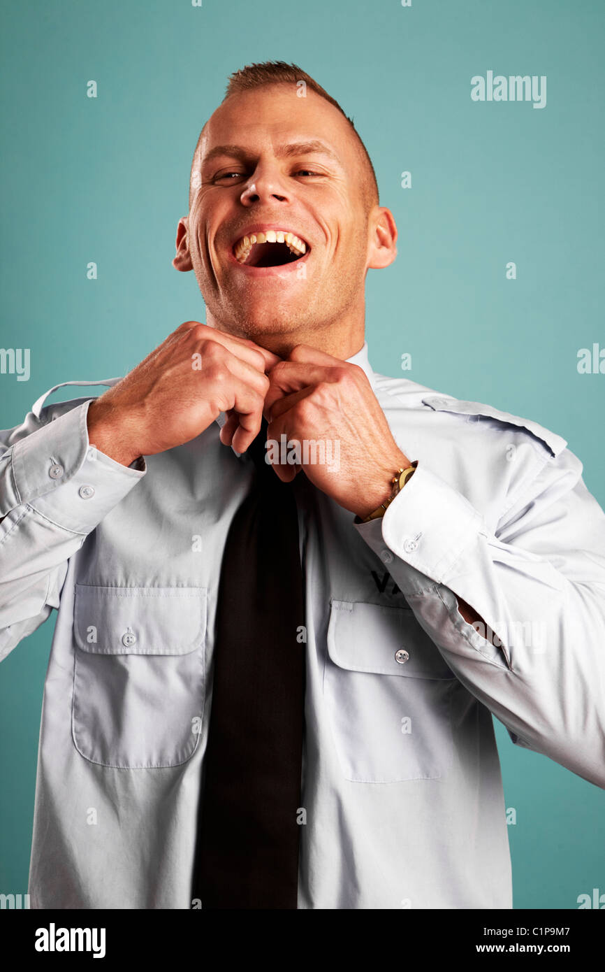 Security guard adjusting tie, portrait Stock Photo - Alamy