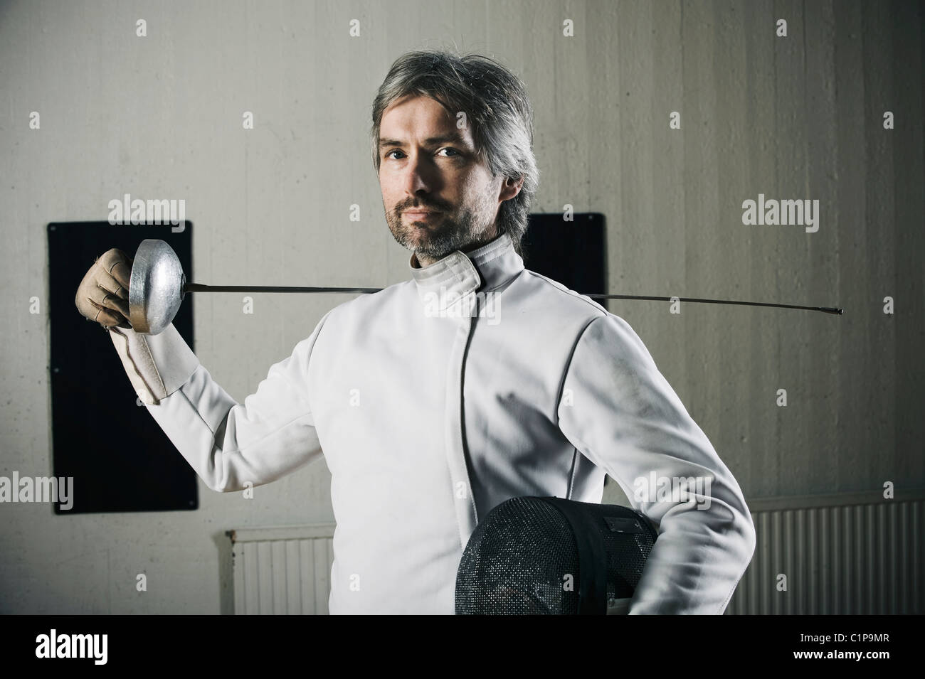 Portrait of male fencer in sports hall Stock Photo - Alamy