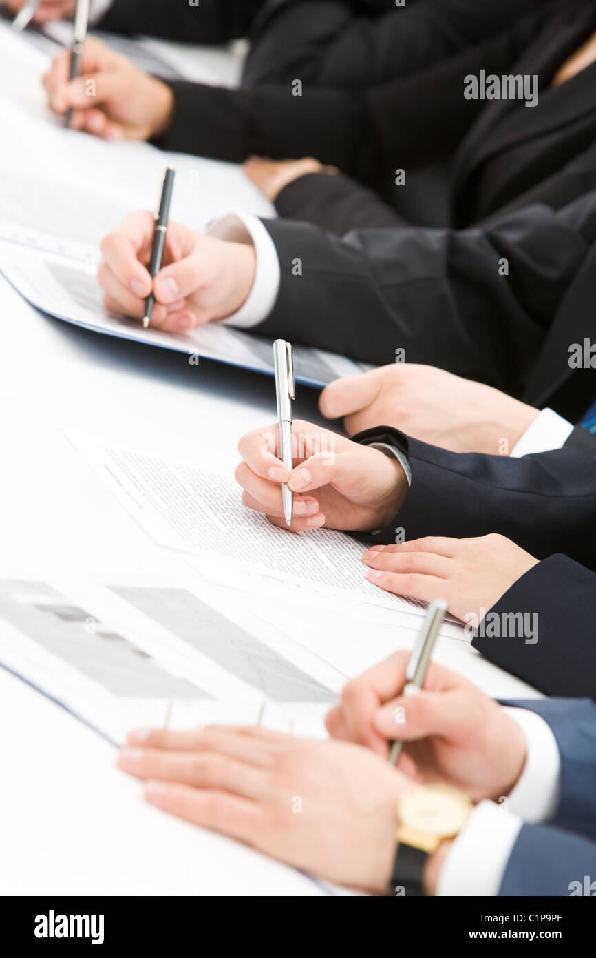 Image of row of people hands writing on papers at seminar Stock Photo ...