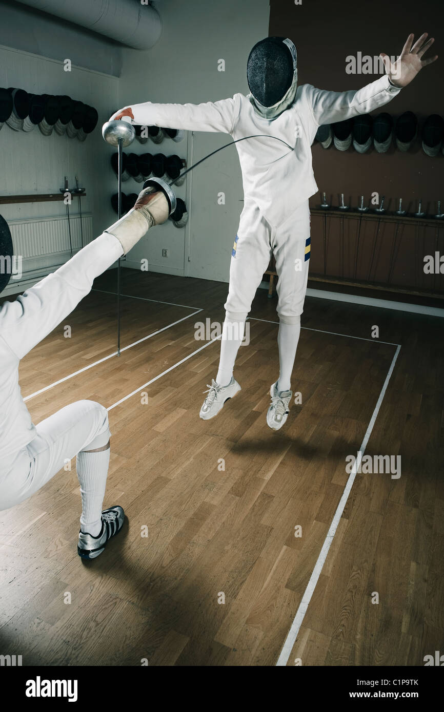 Two fencers in sports hall Stock Photo - Alamy