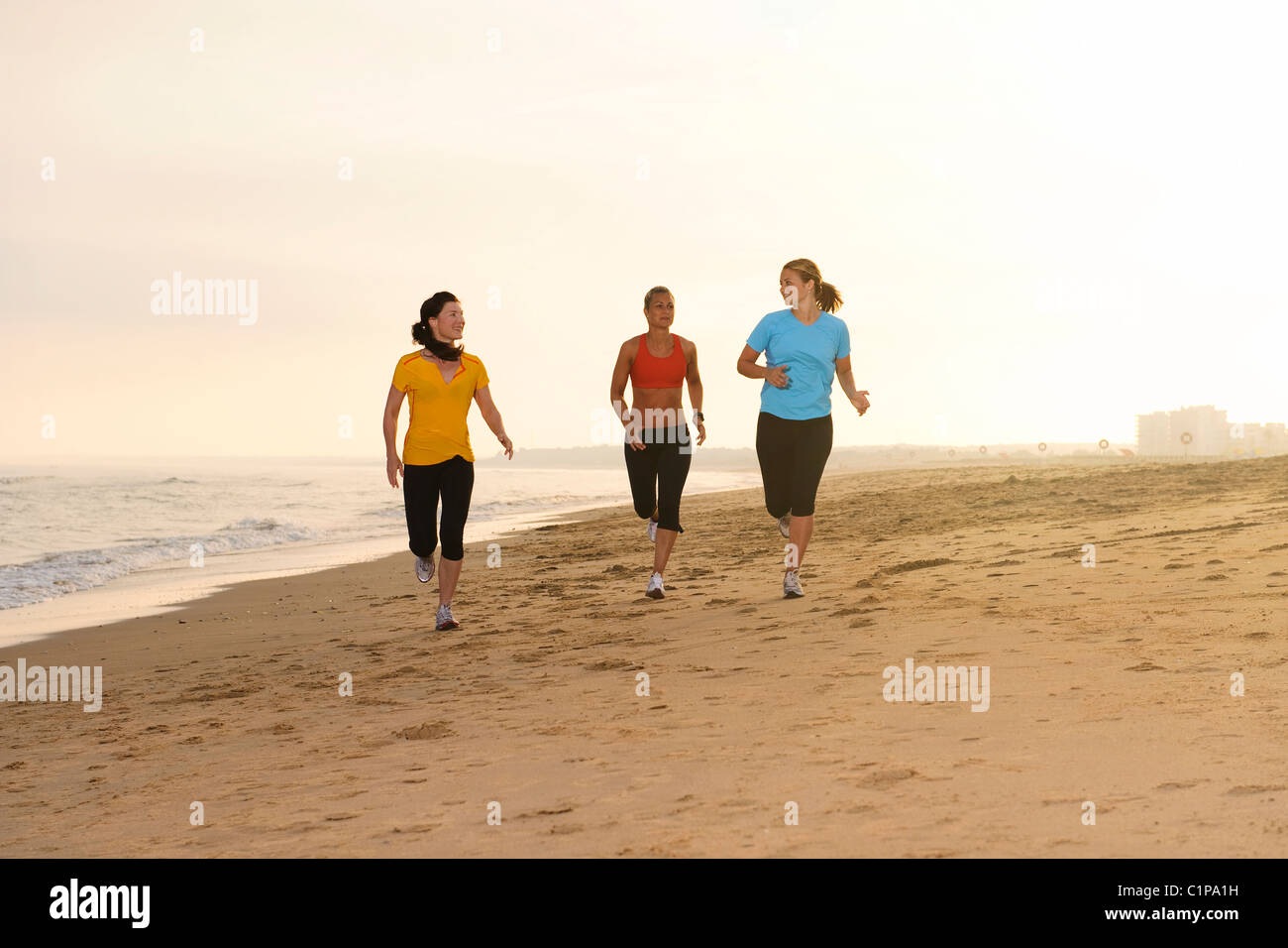 Women jogging on beach Stock Photo - Alamy
