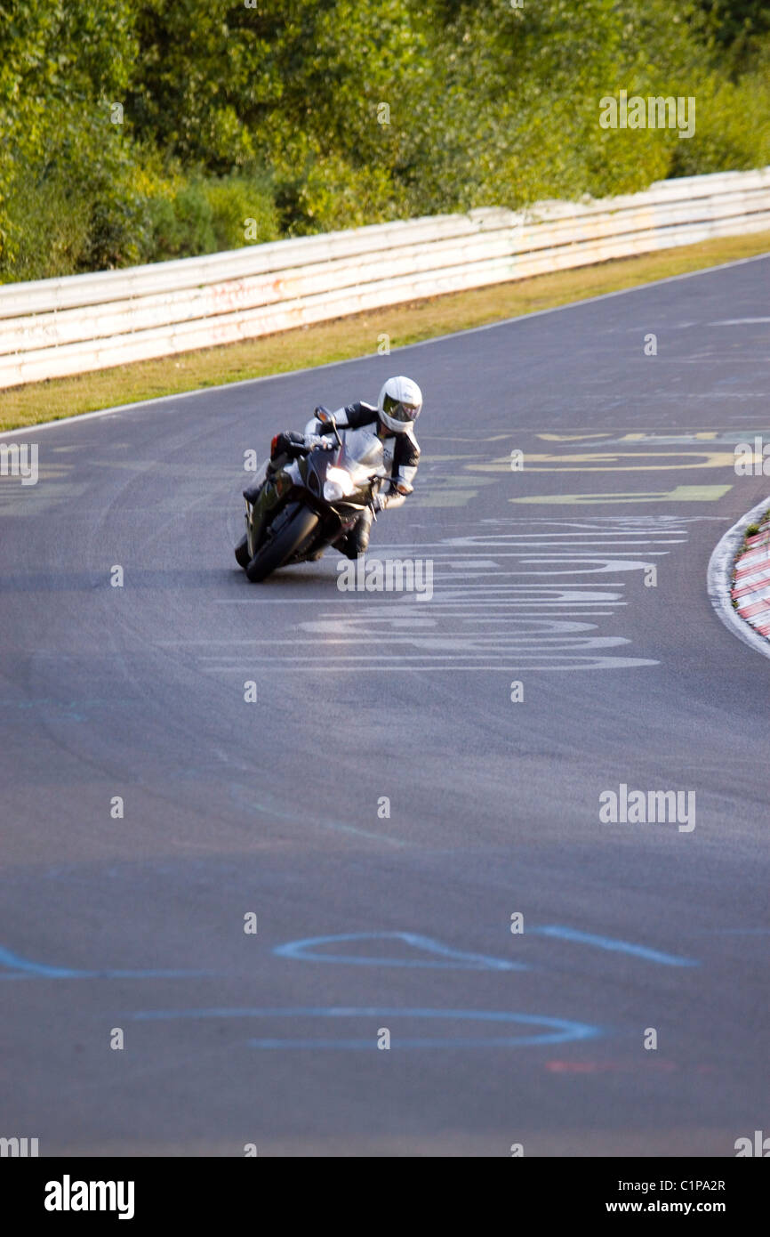Germany, Nurburgring, Nordschleife, man riding motorcycle on racetrack ...