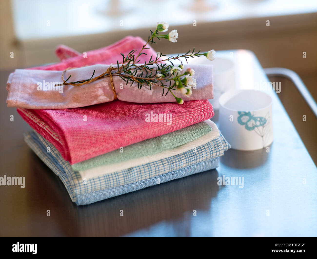 Clothes in stack with blossoming branch on the top Stock Photo - Alamy