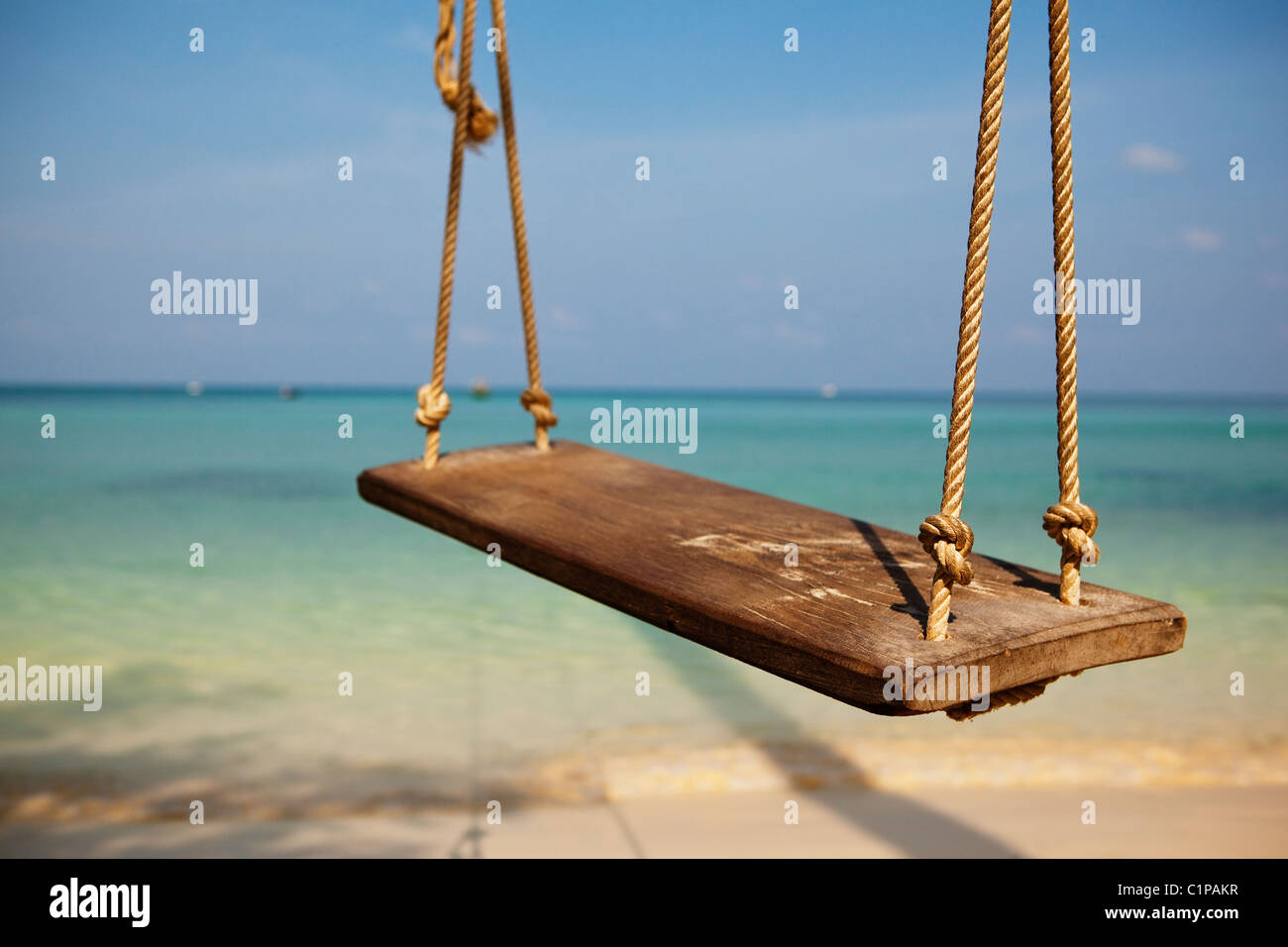 Rope swing on beach Stock Photo - Alamy