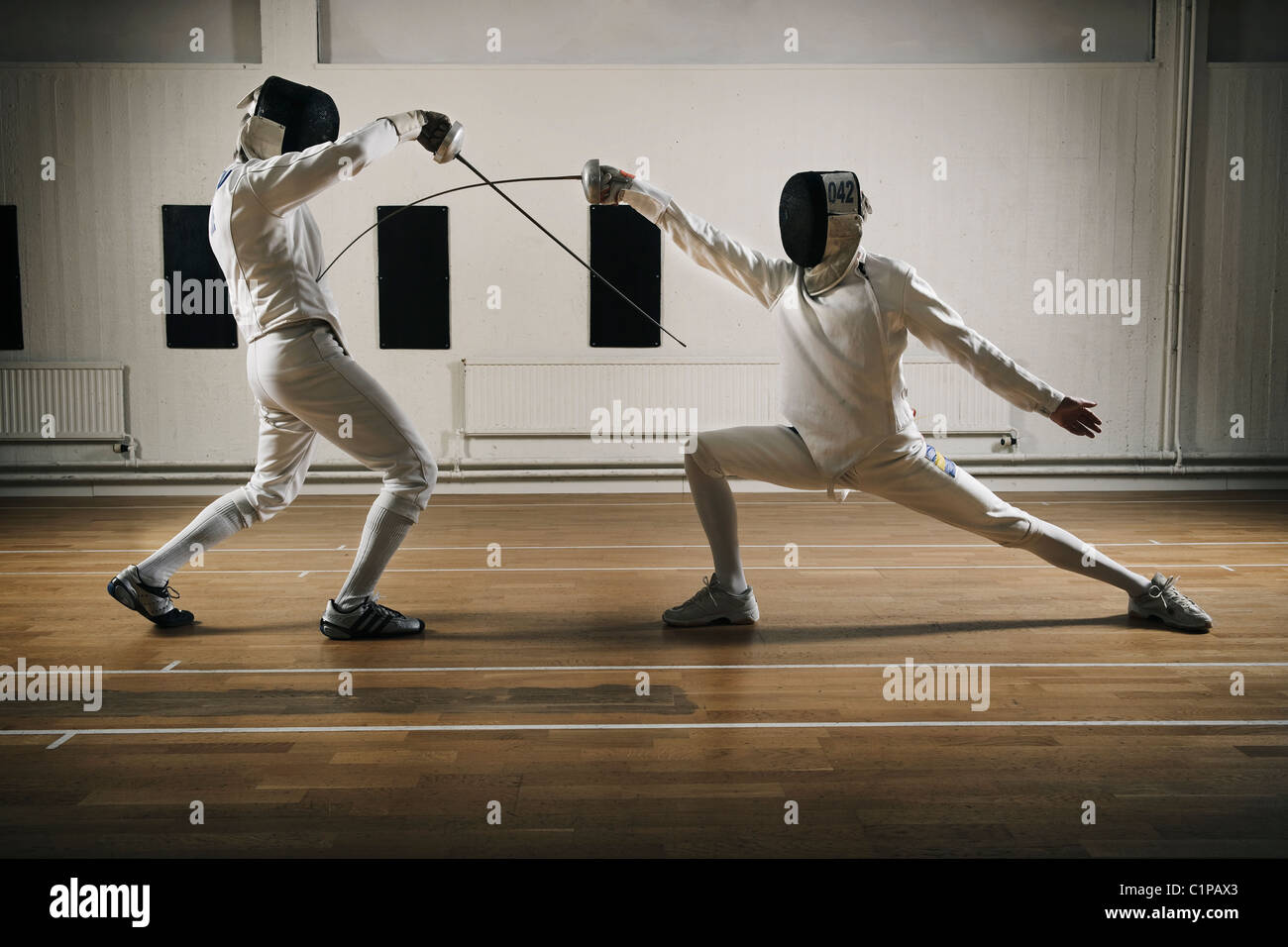 Two fencers in sports hall Stock Photo - Alamy