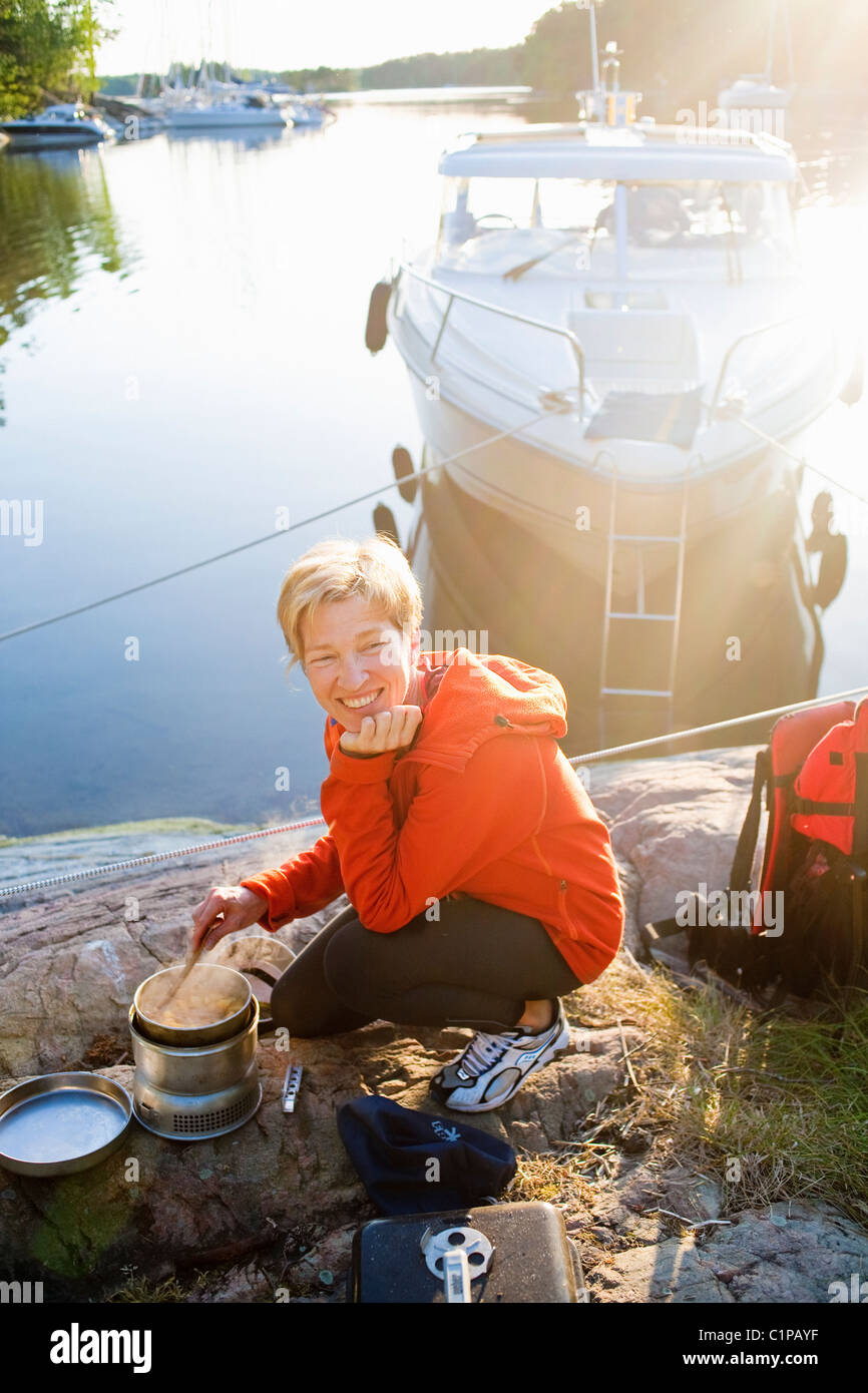 Woman cooking in marina Stock Photo - Alamy