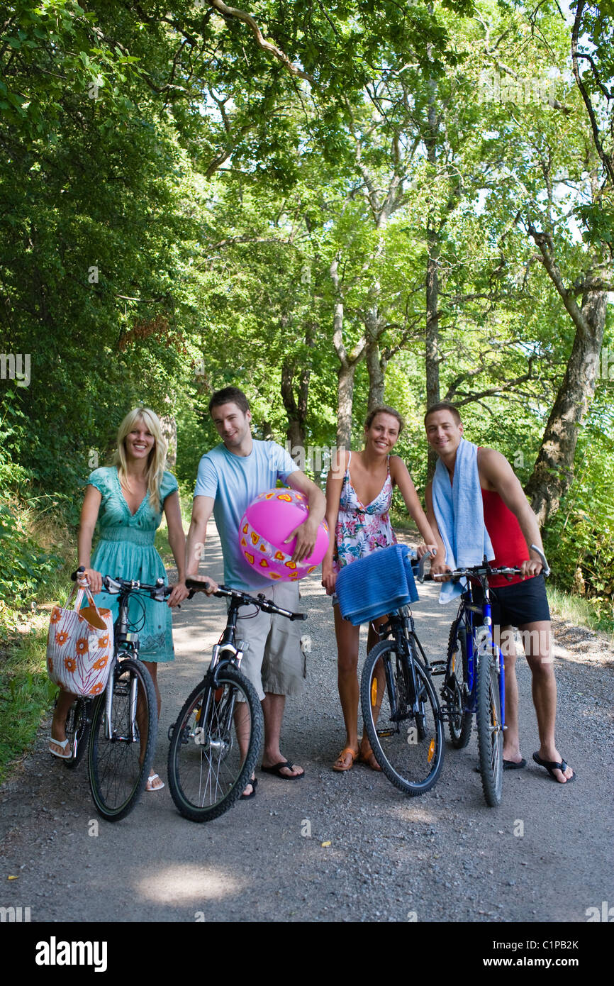 Portrait of four friends with mountain bikes in forest Stock Photo - Alamy