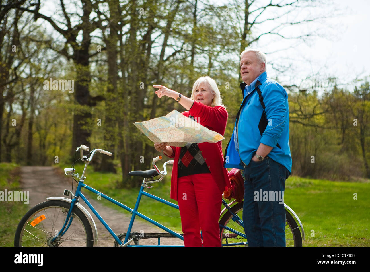Senior couple with tandem bicycle Stock Photo - Alamy