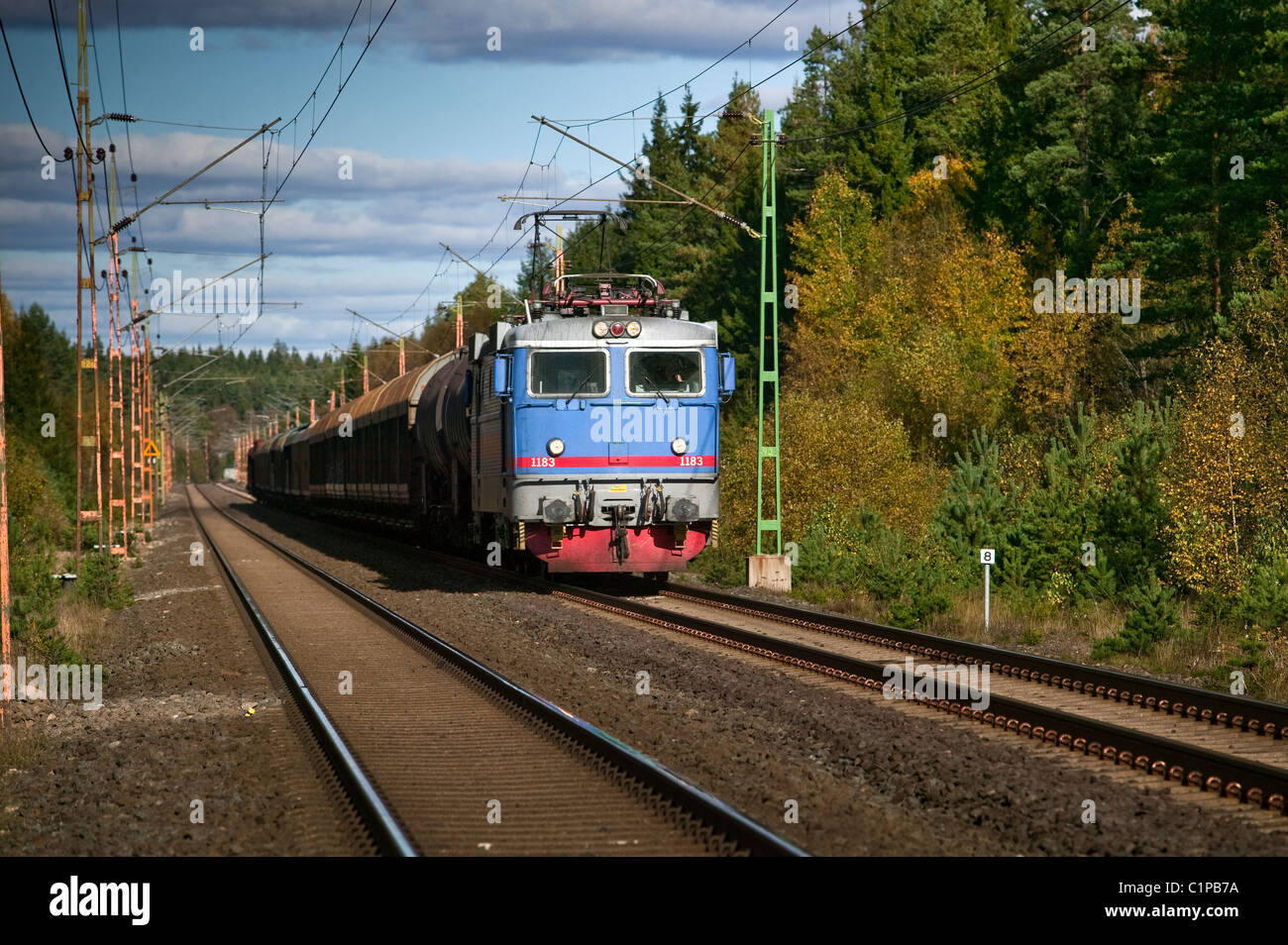 Train on railroad track Stock Photo - Alamy