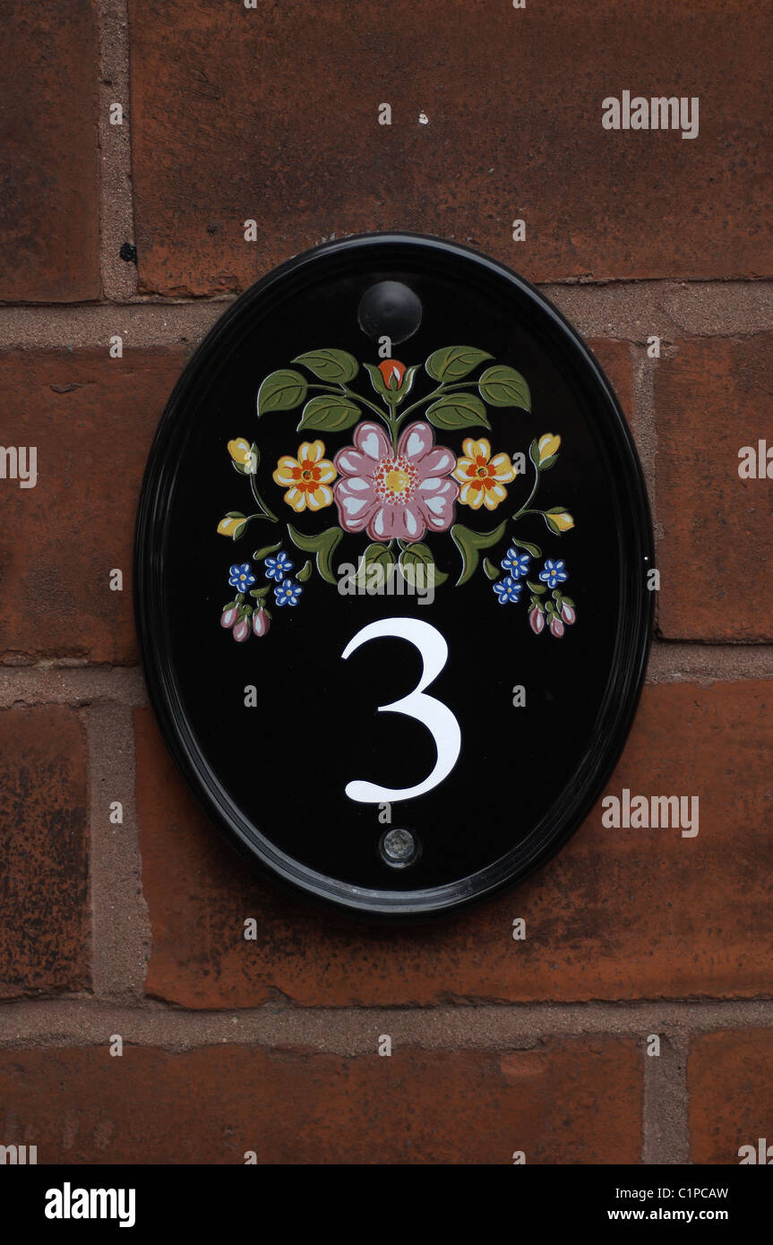 Signs from the British high street. number 3, house, on a brick wall ...