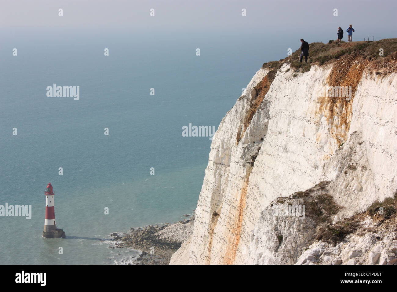 England, Beachy Head, people on top of white cliff with lighthouse ...
