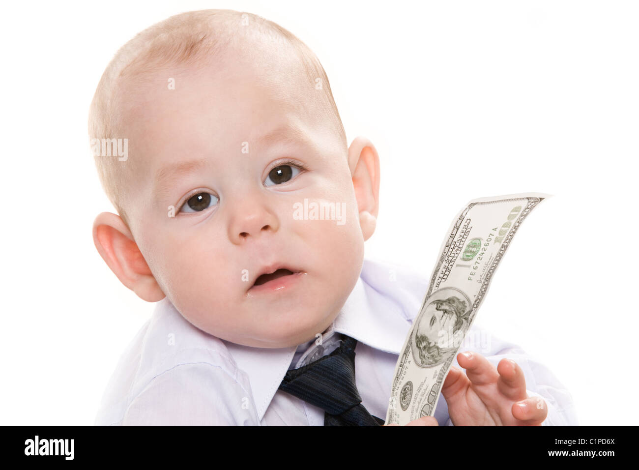 Portrait of serious baby boy with dollar banknote looking at camera ...